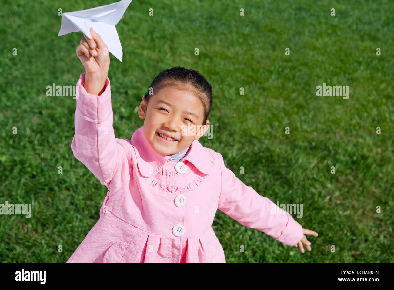 A young girl throwing a paper airplane Stock Photo - Alamy