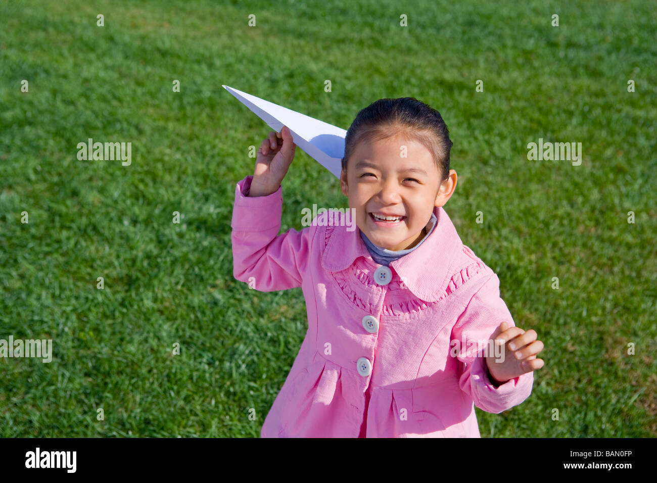 A young girl throwing a paper airplane Stock Photo - Alamy