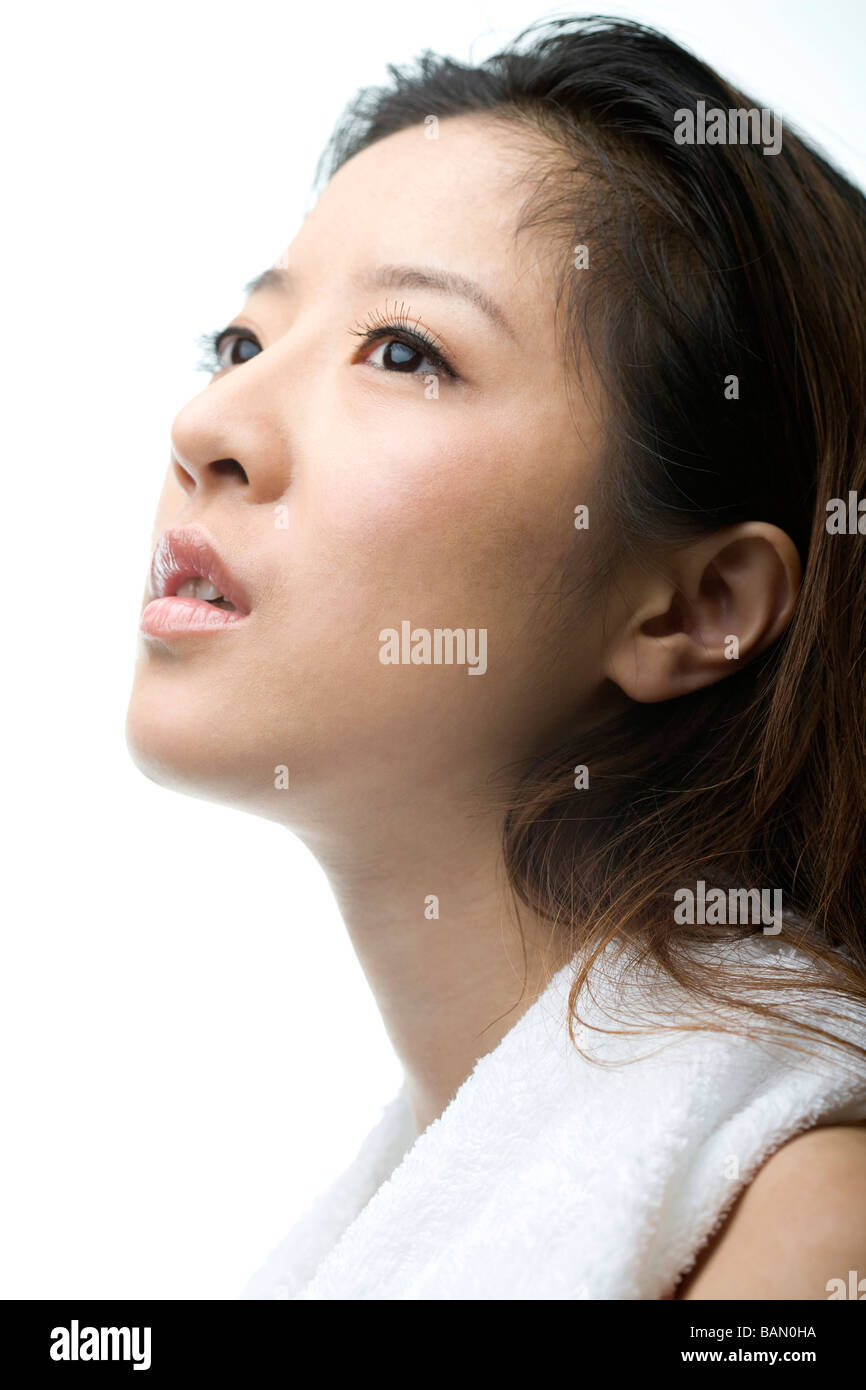 Young woman looking pensive Stock Photo - Alamy