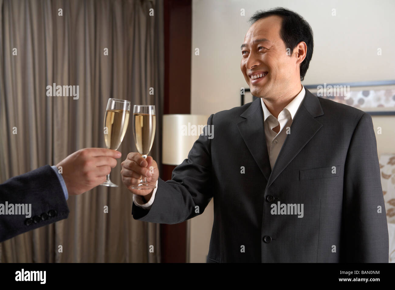 Men in business attire toasting with champagne Stock Photo - Alamy