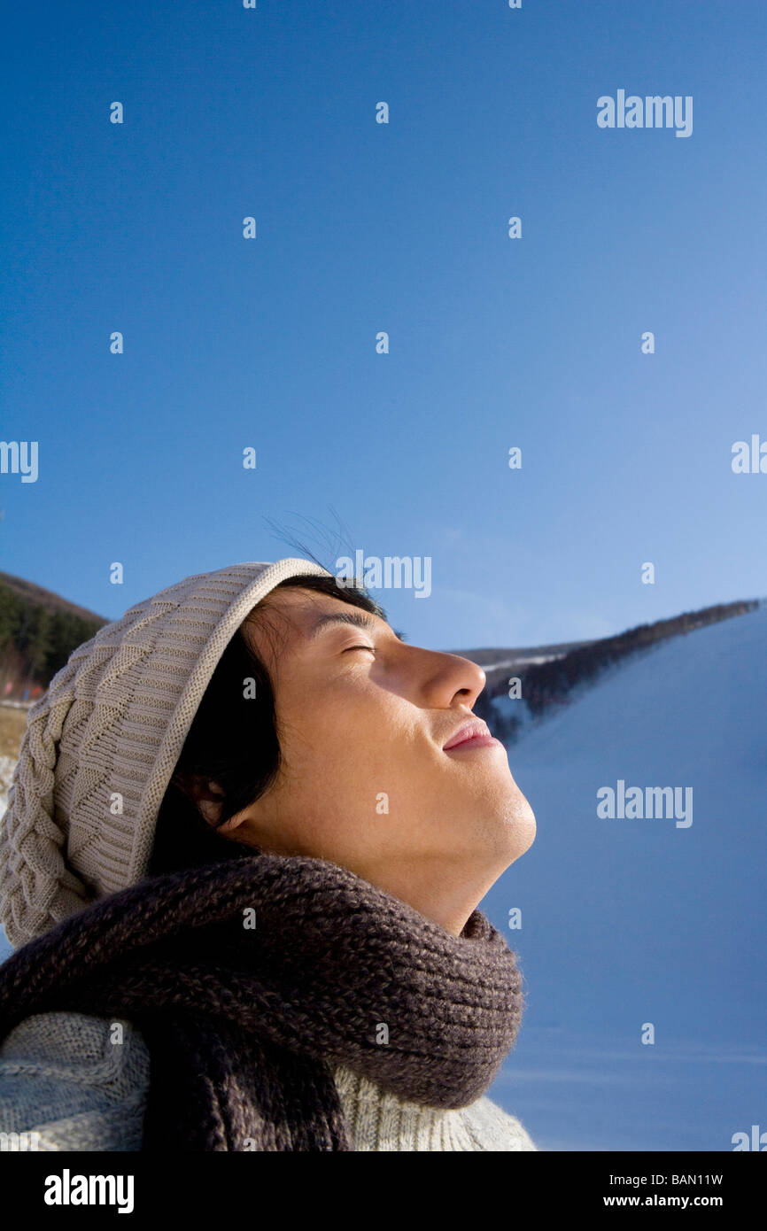 Young man lifting his face to the sun Stock Photo - Alamy