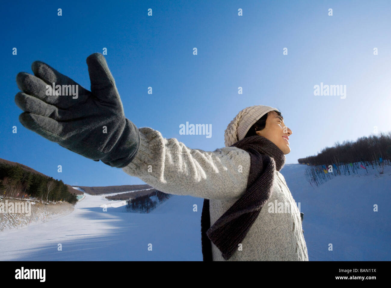 Side view of a young man with his arms outstretched Stock Photo - Alamy