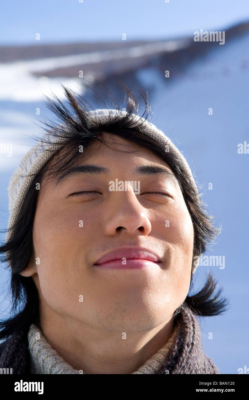 Young man with his eyes closed, smiling Stock Photo - Alamy