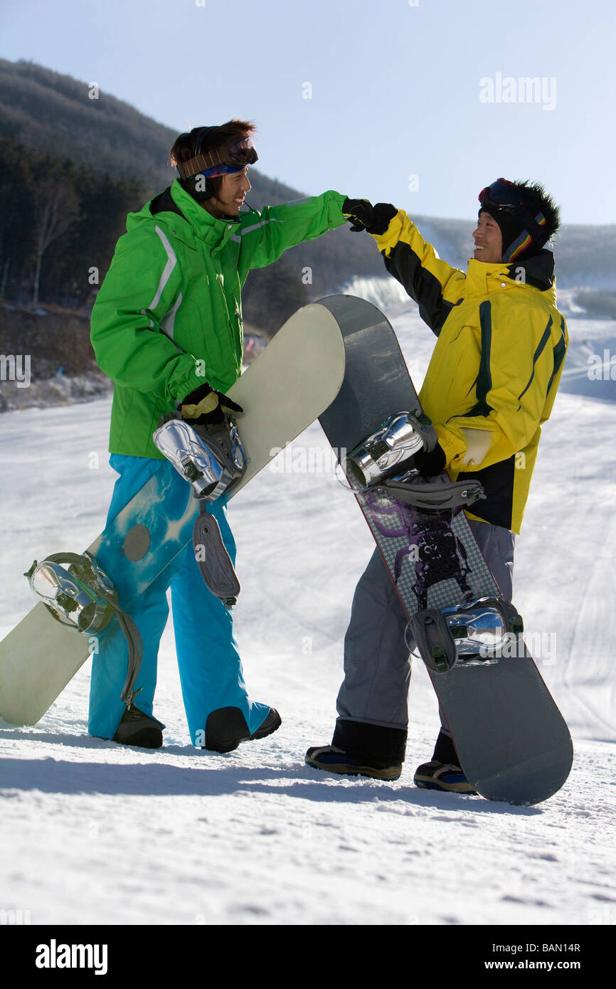 Two young men with their snowboards Stock Photo - Alamy