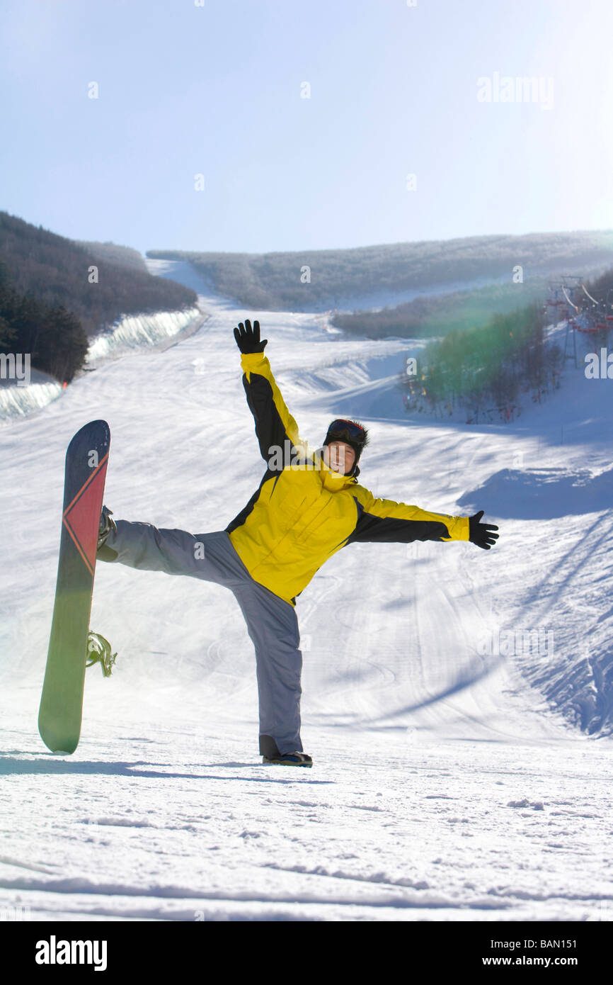 Young man posing with his snowboard Stock Photo - Alamy