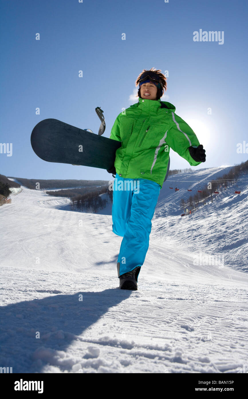 Young man carrying snowboard in hi-res stock photography and images - Alamy
