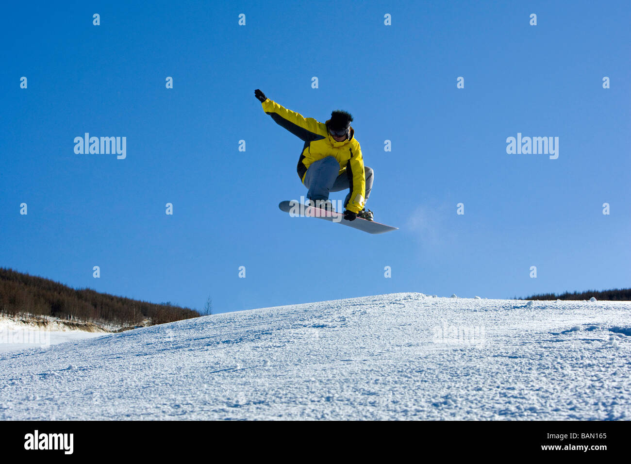 A young man snowboarding Stock Photo - Alamy