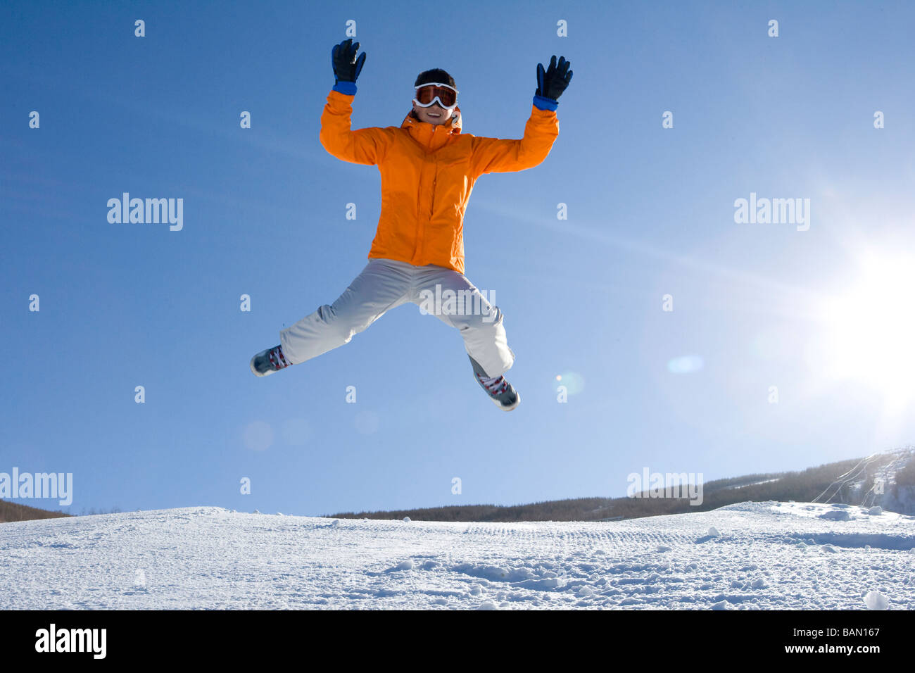 A young woman jumping mid-air Stock Photo - Alamy