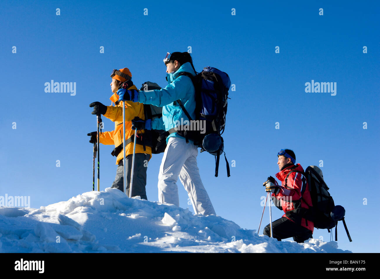Three people hiking Stock Photo - Alamy