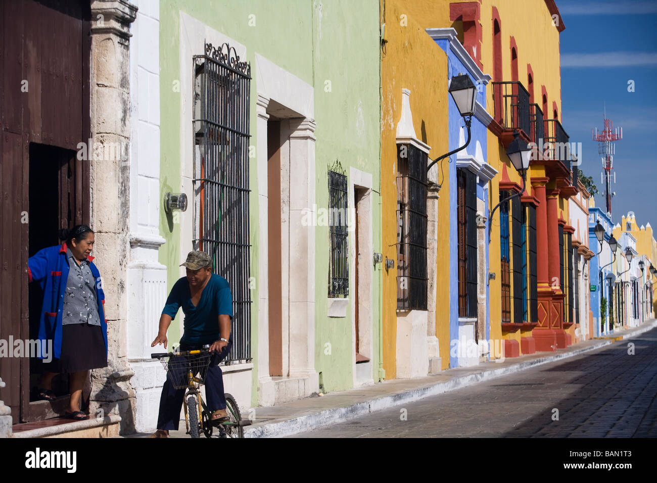 Two neighbours chatting on a colourful Street in Campeche Mexico Stock ...