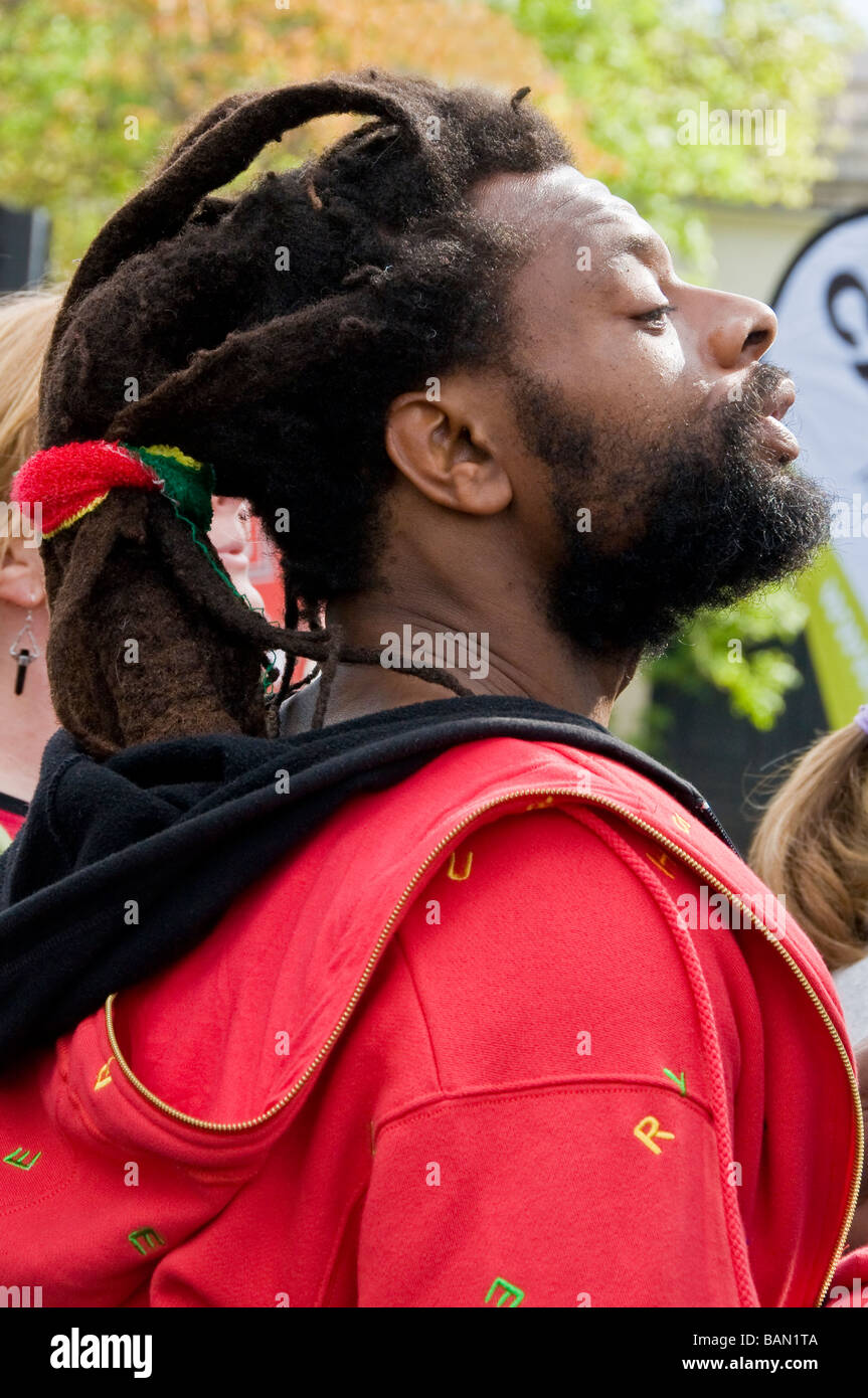 A young black man with dreadlocks watching London Marathon 2009 ...