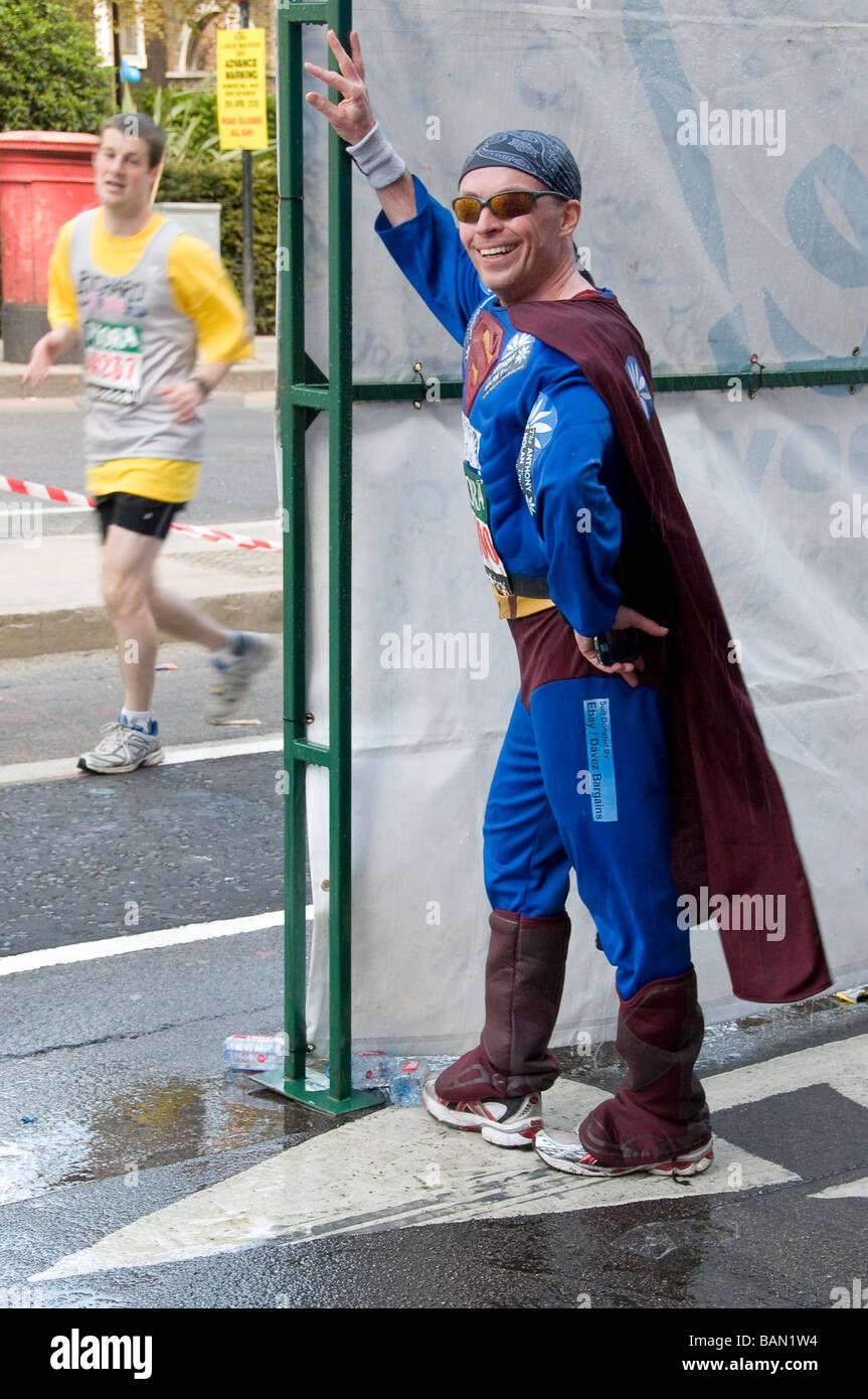 A young man dressed up as a Superman posing for a camera at London ...