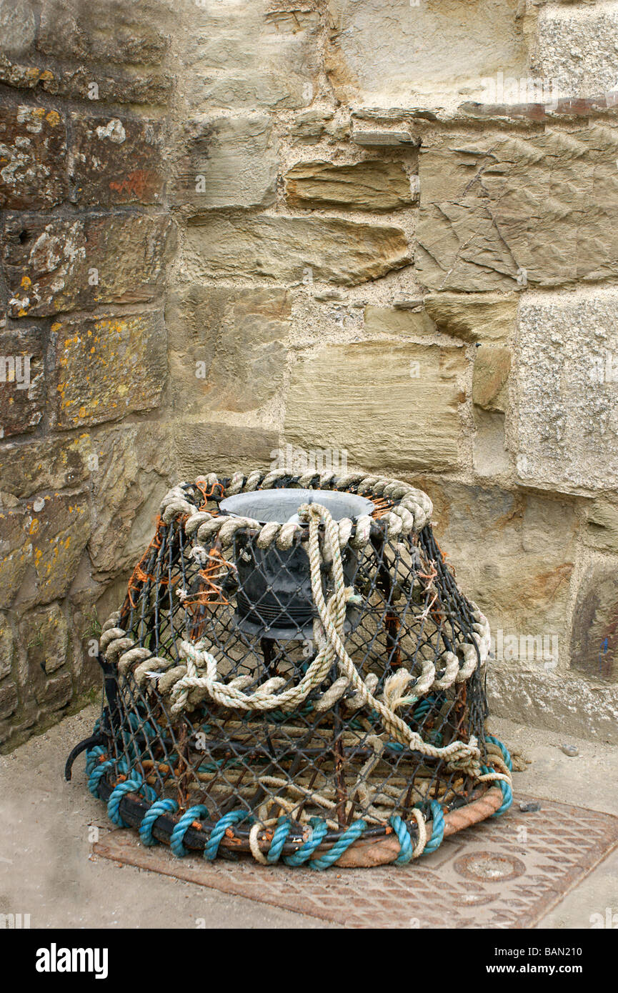 Fishing pot and Cornish stone wall Stock Photo - Alamy
