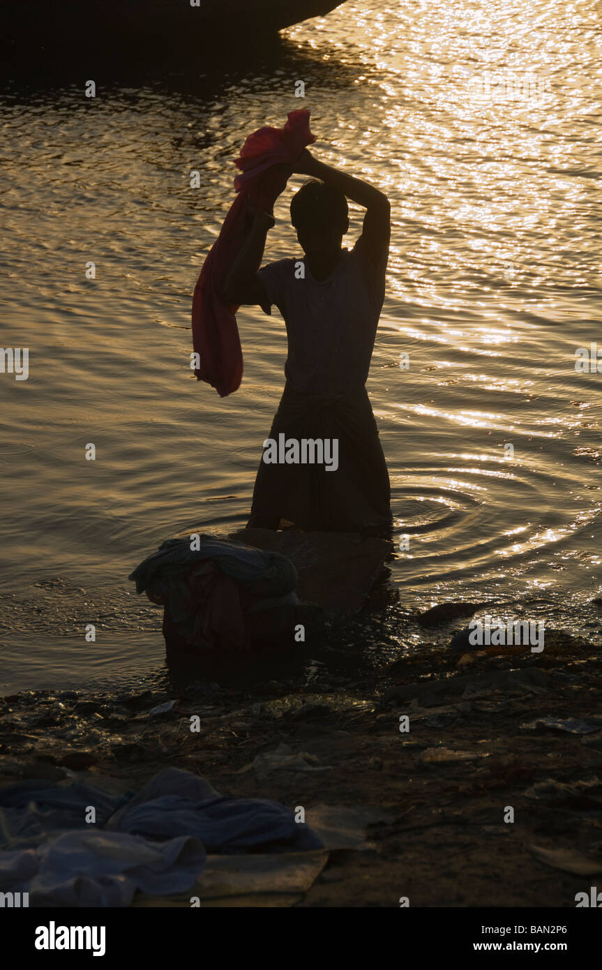 Indian Man washing clothes in the Gange Varanasi Benares Uttar Pradesh ...