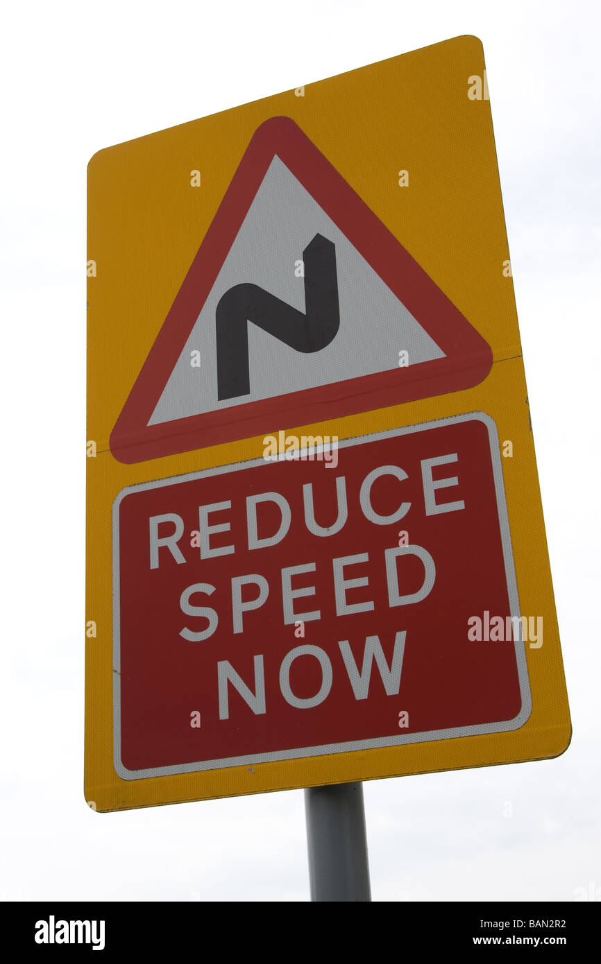 "Reduce Speed Now" sign on UK road Stock Photo - Alamy