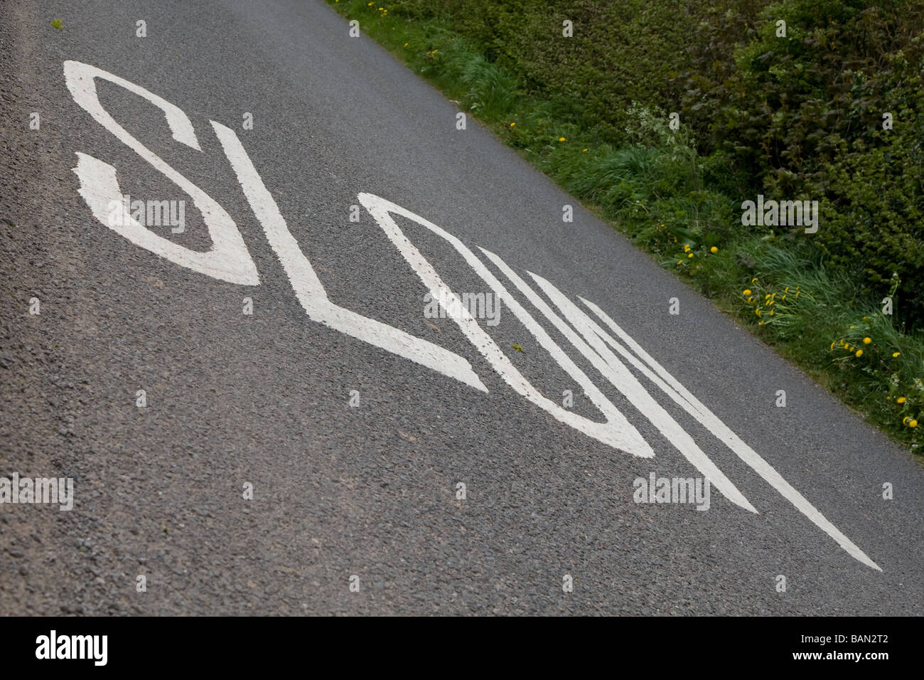 "Slow" warning on UK road Stock Photo - Alamy