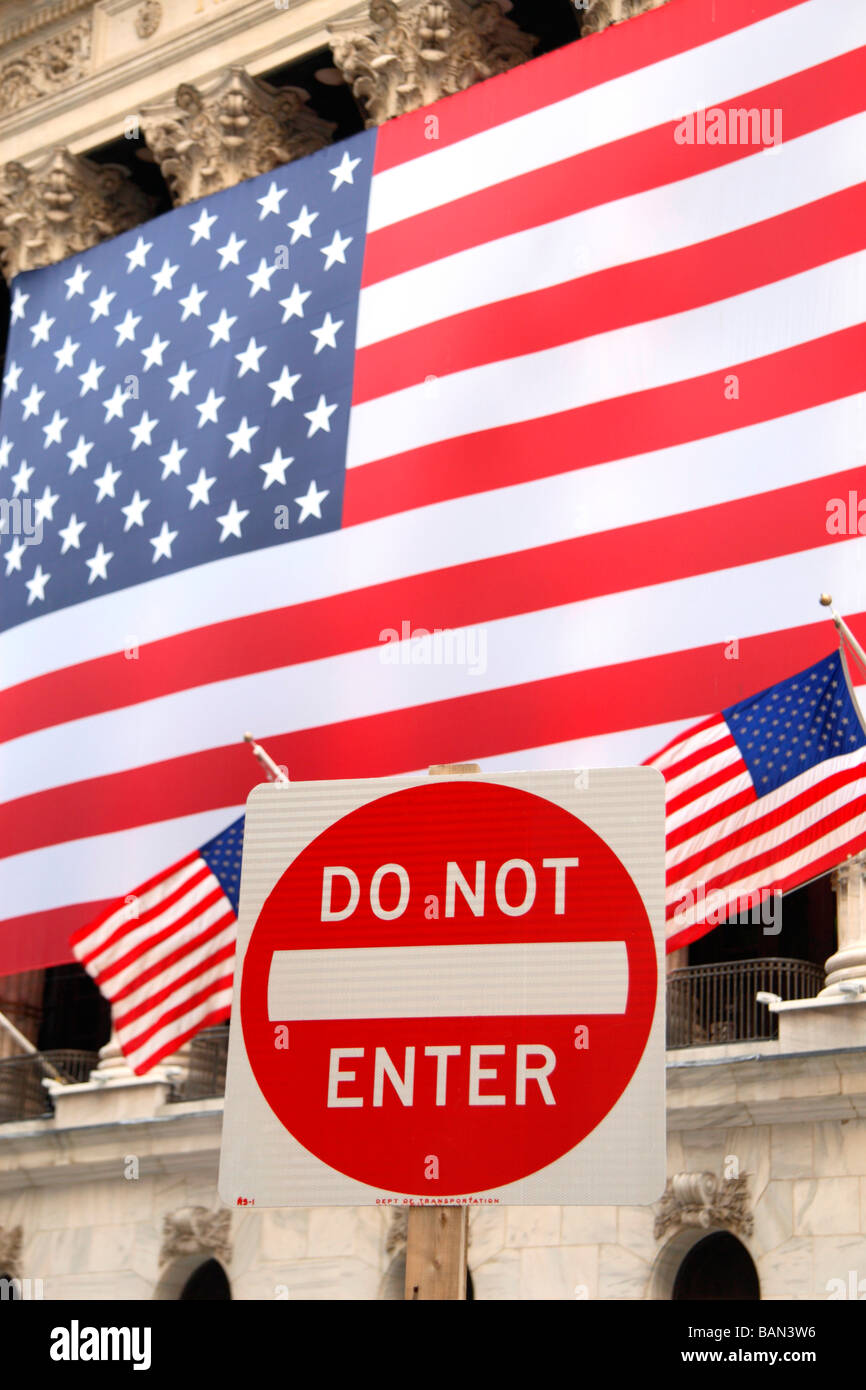 A 'Do Not Enter' road sign in front of the Star Spangled Banner flying ...