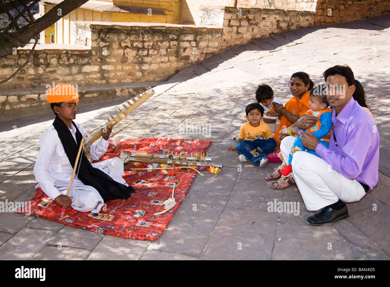 Young man playing a ravan hatta musical instrument, at Mehrangarh Fort ...