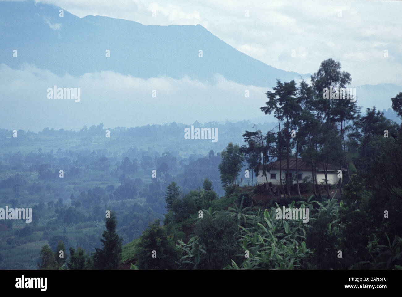 House in the foothills of the Virunga range of volcanoes on the border ...