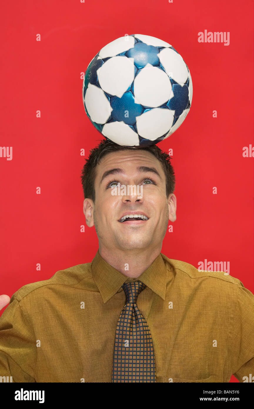 Businessman headering a soccer ball Stock Photo - Alamy