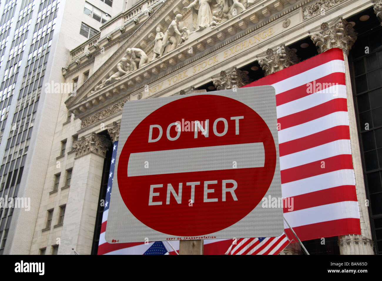 A 'Do Not Enter' road sign in front of the Star Spangled Banner flying ...