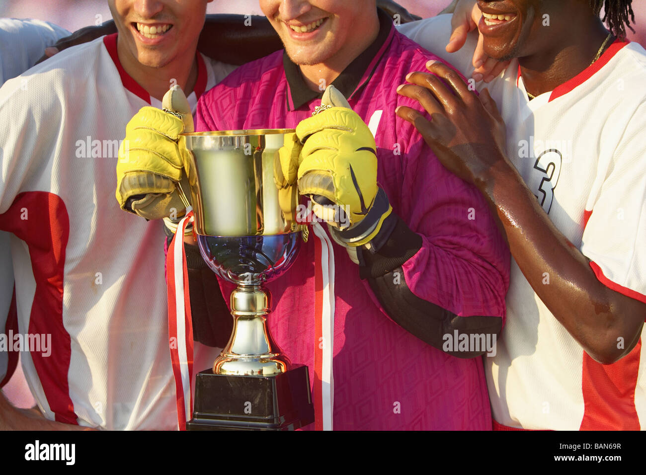 Soccer team triumphantly holding trophy Stock Photo - Alamy