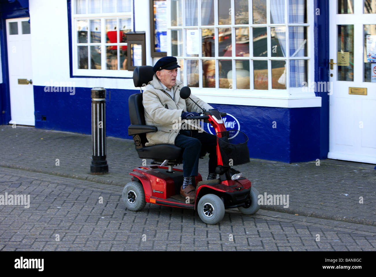 Senior man riding his mobility scooter Stock Photo - Alamy