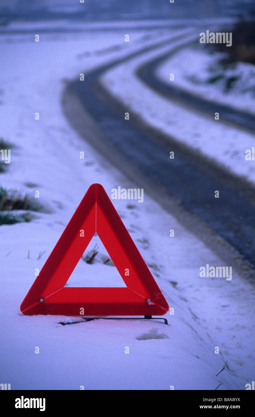 hazard warning triangle at roadside in wintersnow warning of possible ...