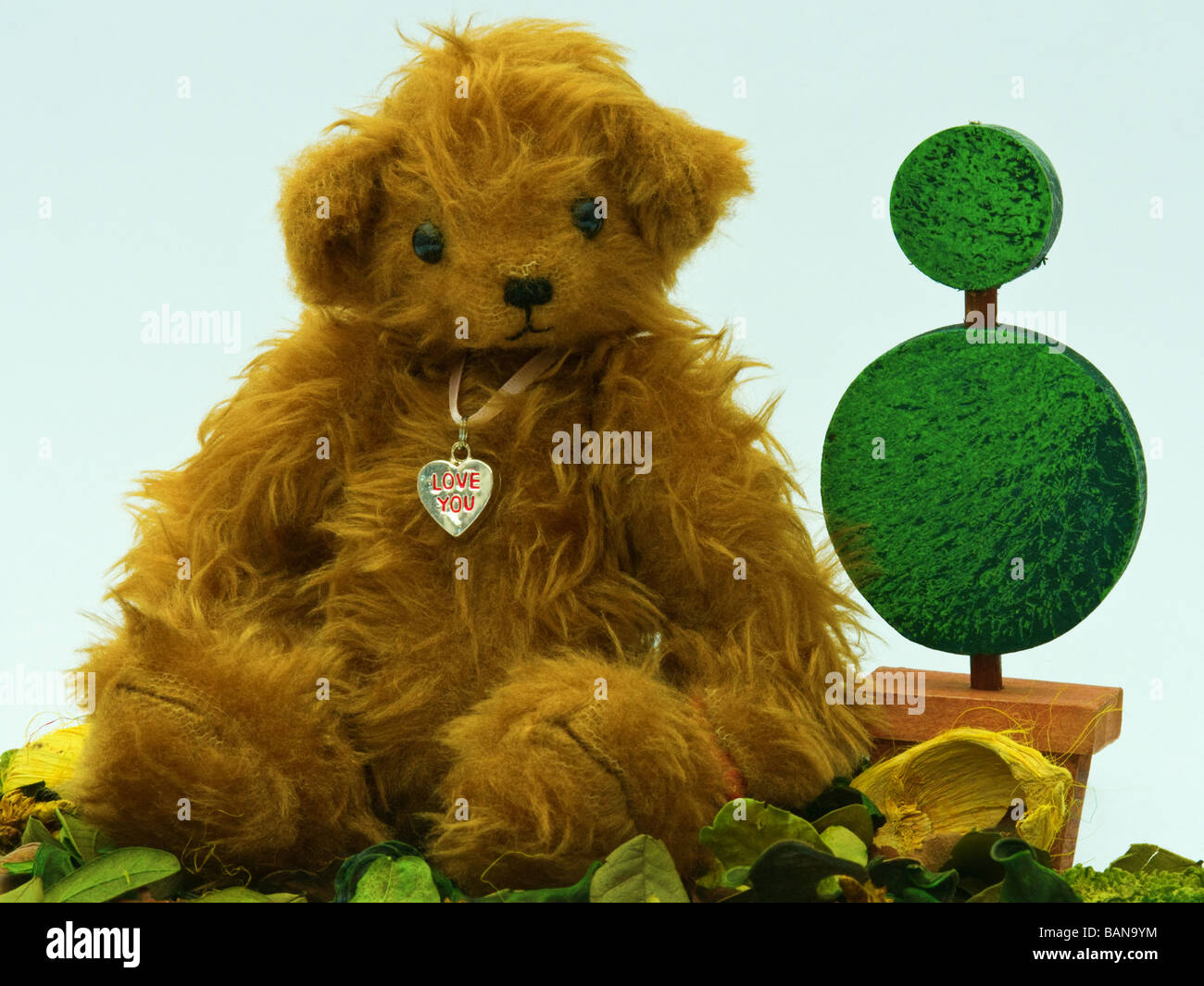 Miniature teddy sitting on a bed of flowers (Mini Bear Collection Stock ...