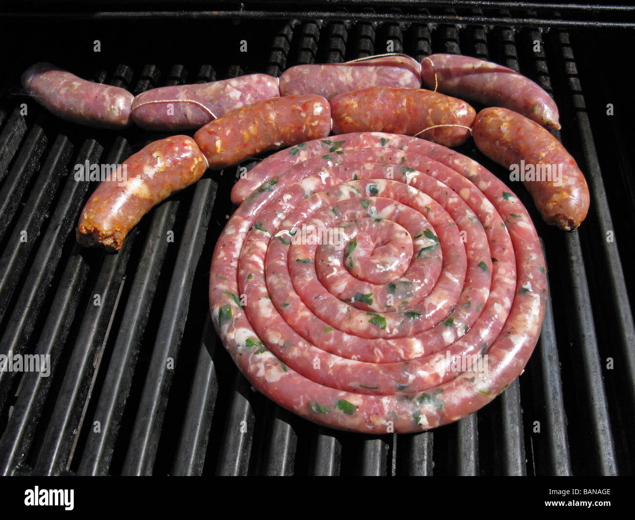 sausages grilling on an outdoor grill Stock Photo - Alamy