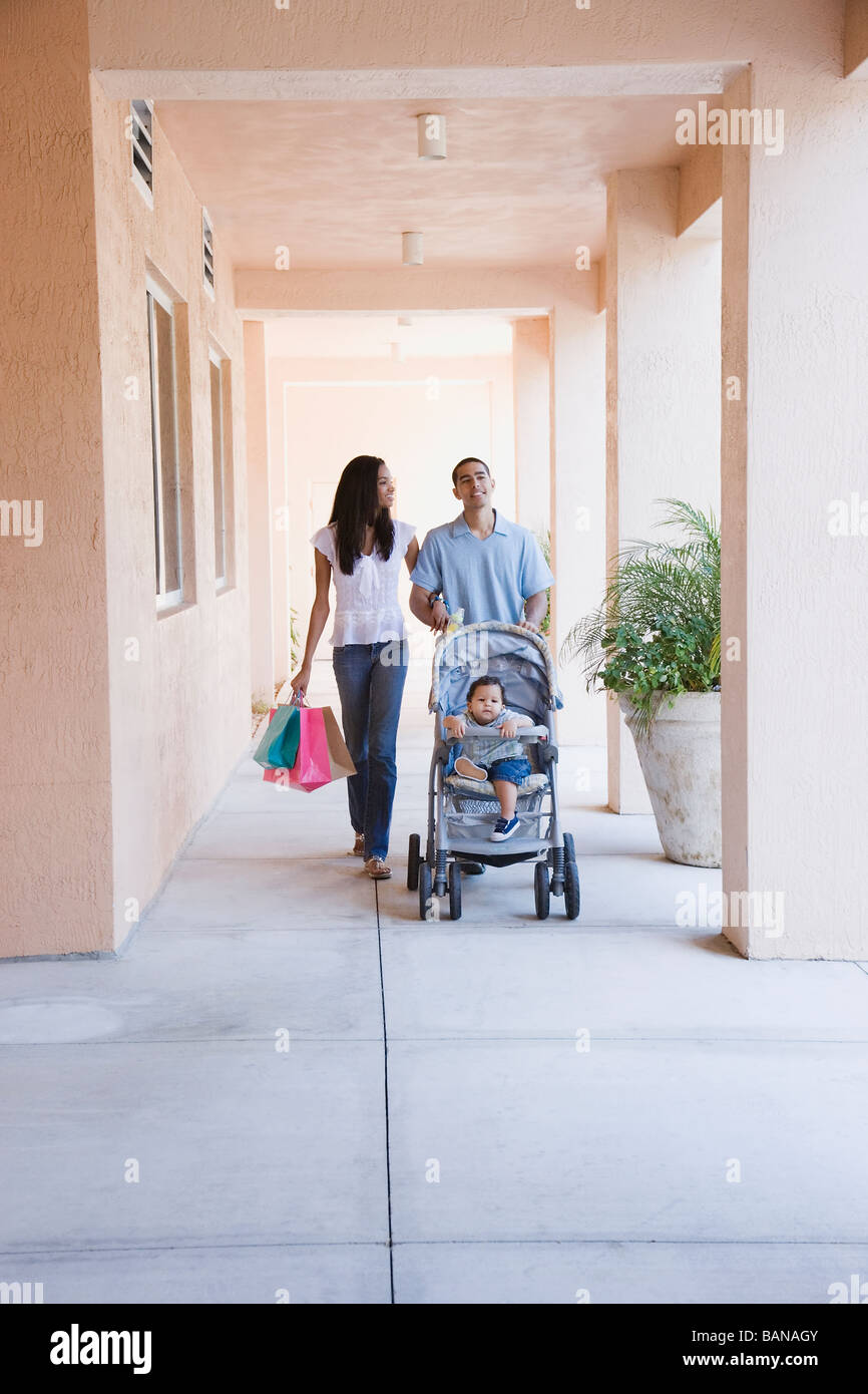 African couple pushing baby in stroller Stock Photo - Alamy