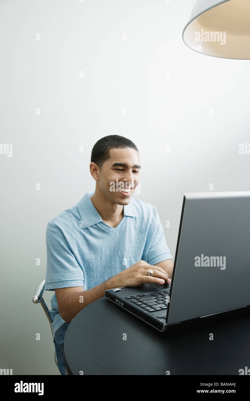 Young African man using laptop Stock Photo - Alamy