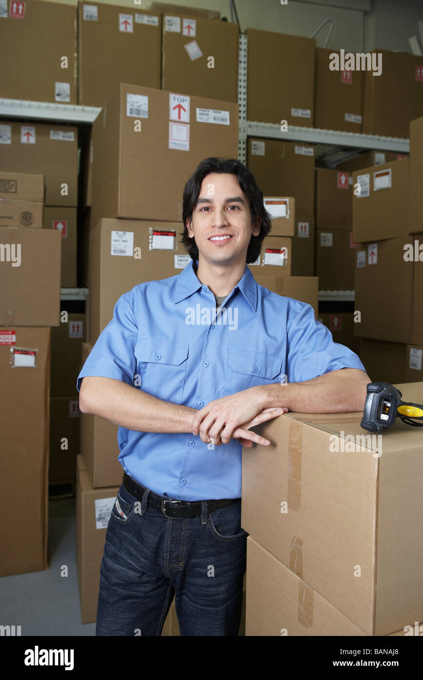 Hispanic male warehouse worker with boxes Stock Photo - Alamy