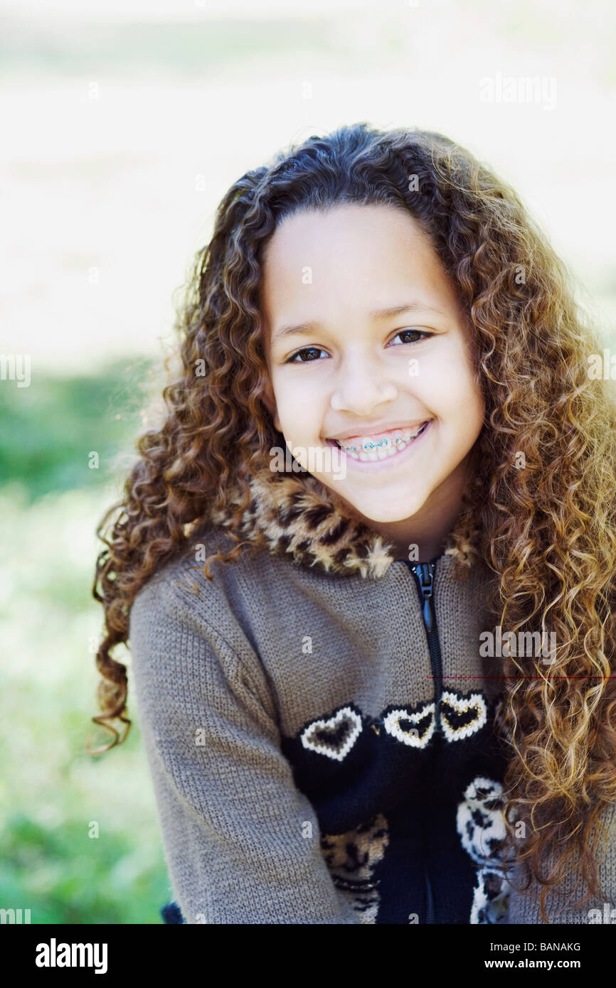 Young African girl with braces smiling Stock Photo - Alamy