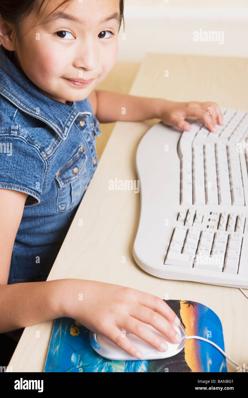 Young Asian girl using computer Stock Photo - Alamy