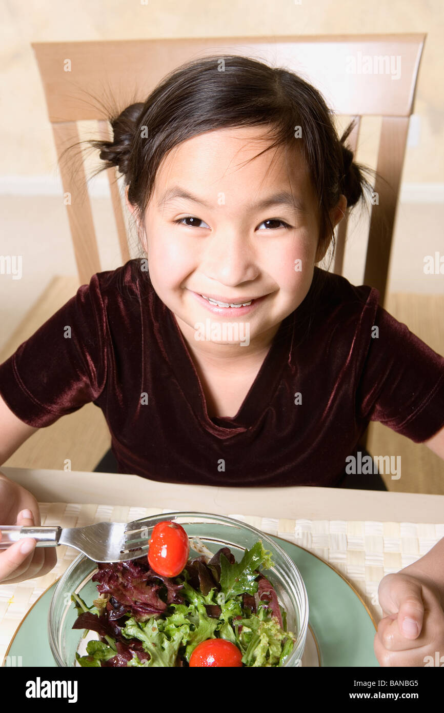 Young Asian girl eating salad Stock Photo - Alamy