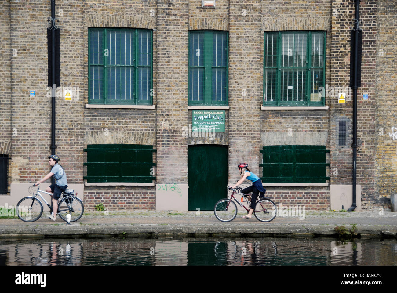 Two cyclists on canal towpath in London's East End Stock Photo - Alamy