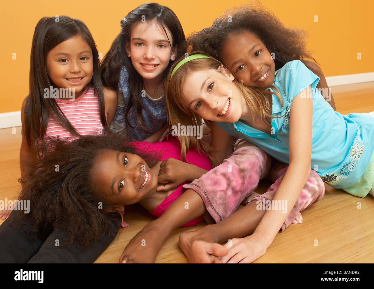 Children laying in pile and smiling Stock Photo - Alamy