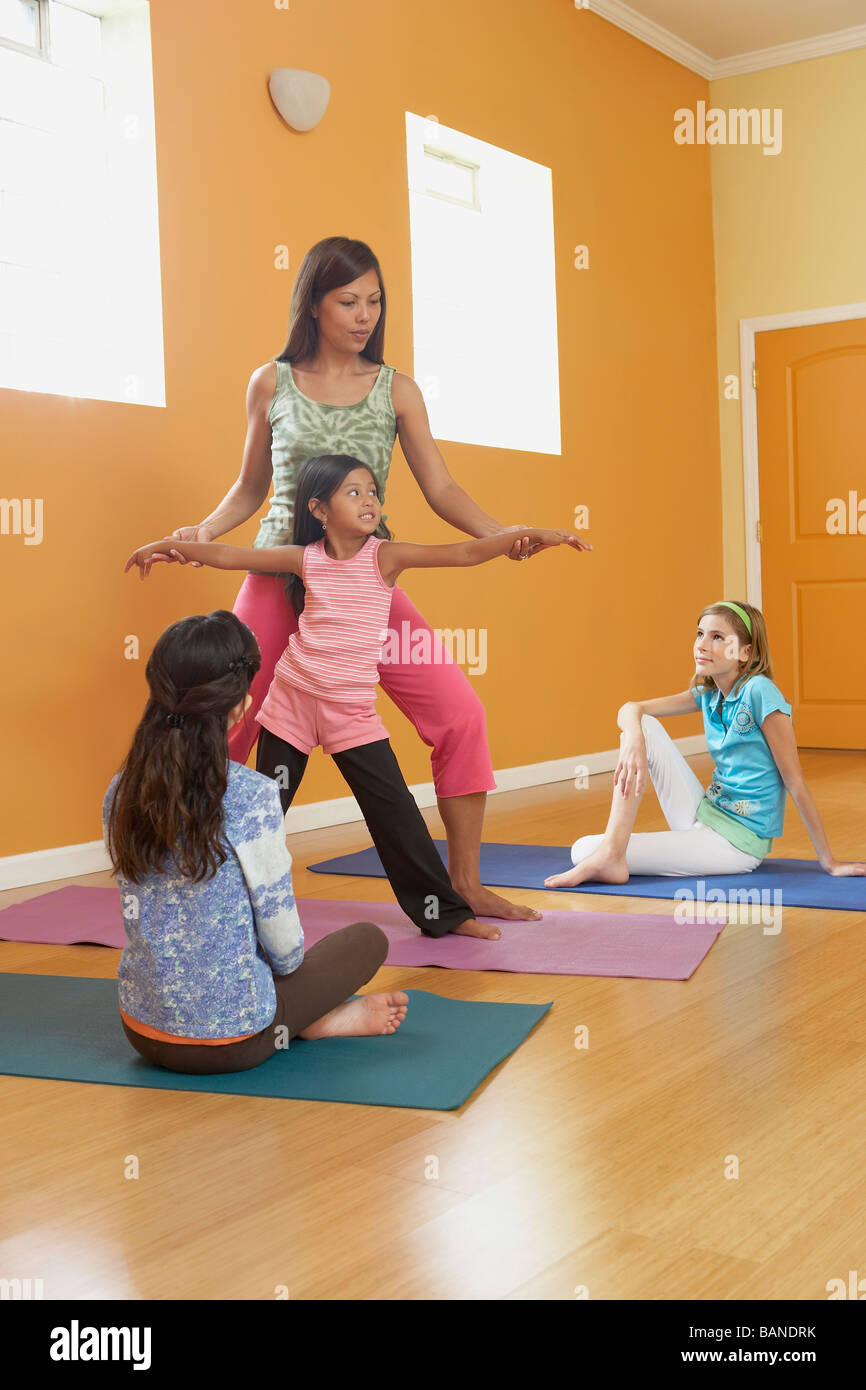 Teacher leading class of children in exercise routine Stock Photo - Alamy