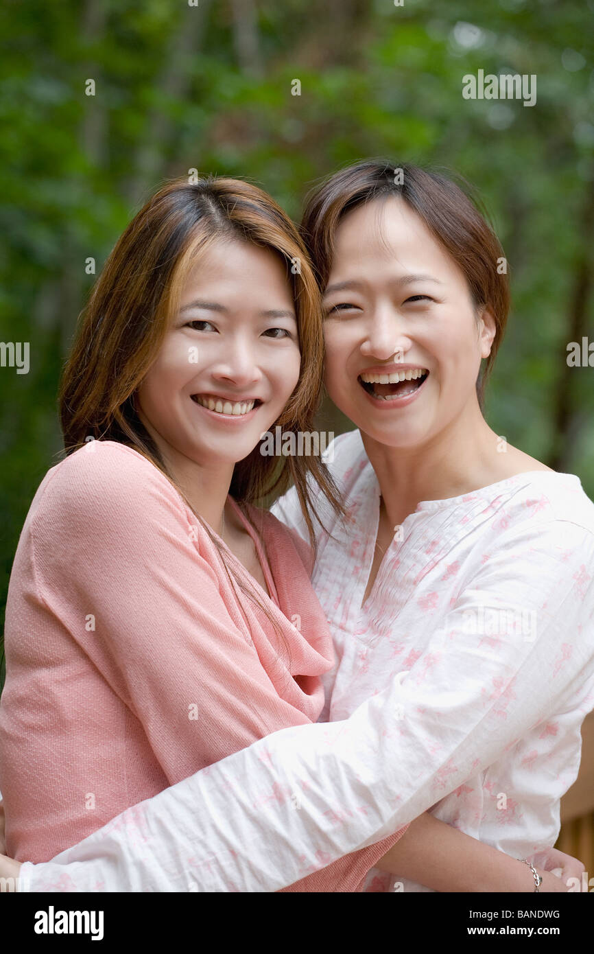Asian sisters hugging Stock Photo - Alamy