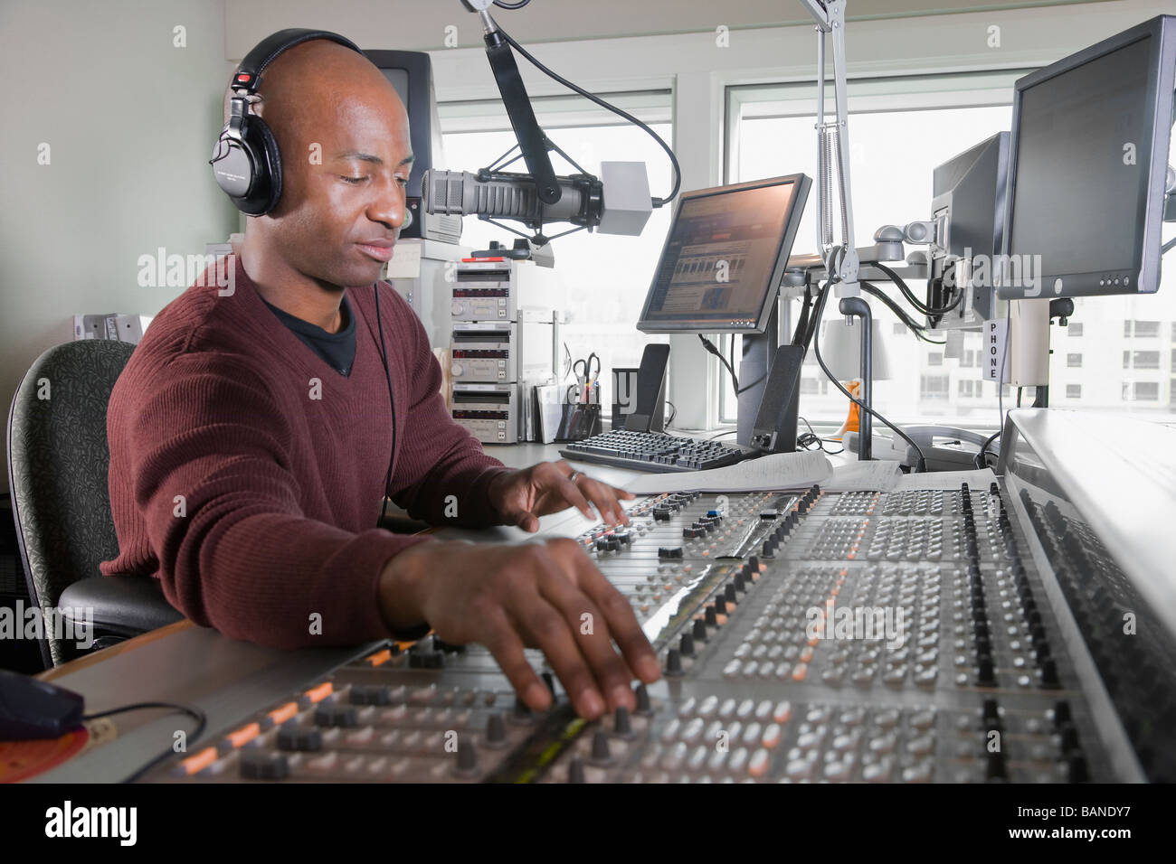 African dj working at radio station Stock Photo - Alamy