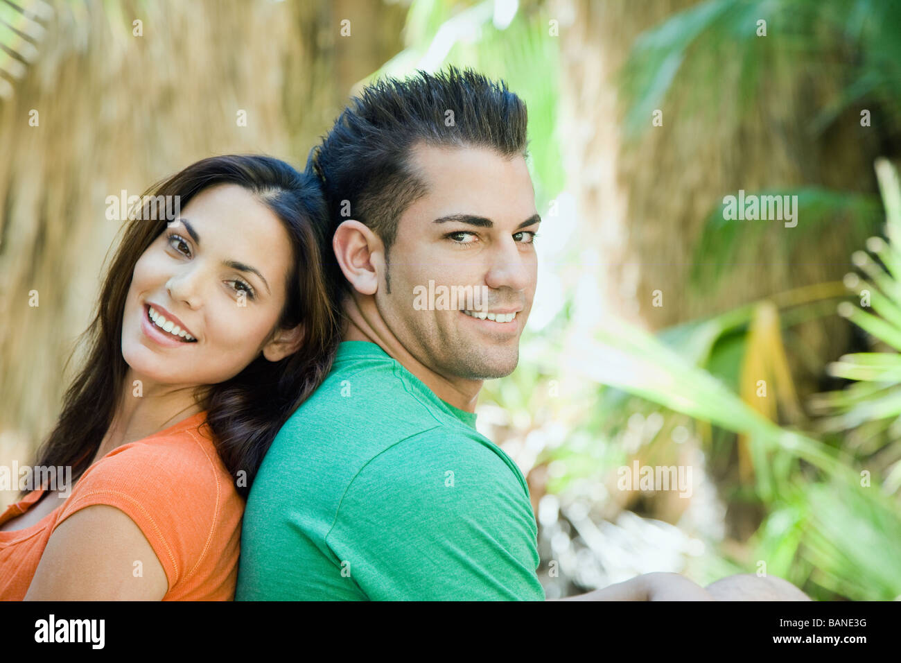 Hispanic couple relaxing in tropical area Stock Photo - Alamy