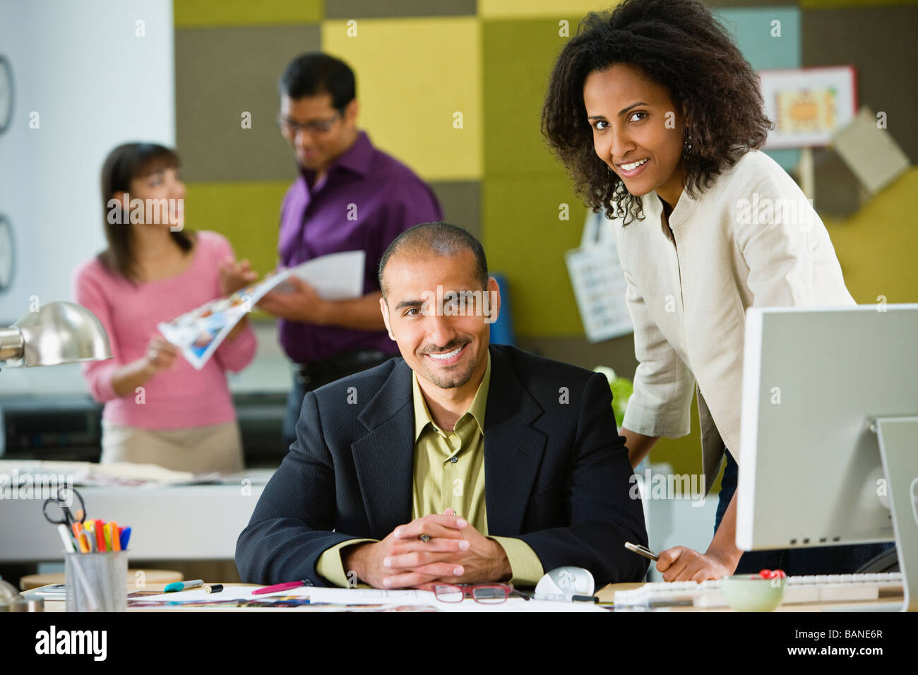 Business people standing at office desk Stock Photo - Alamy