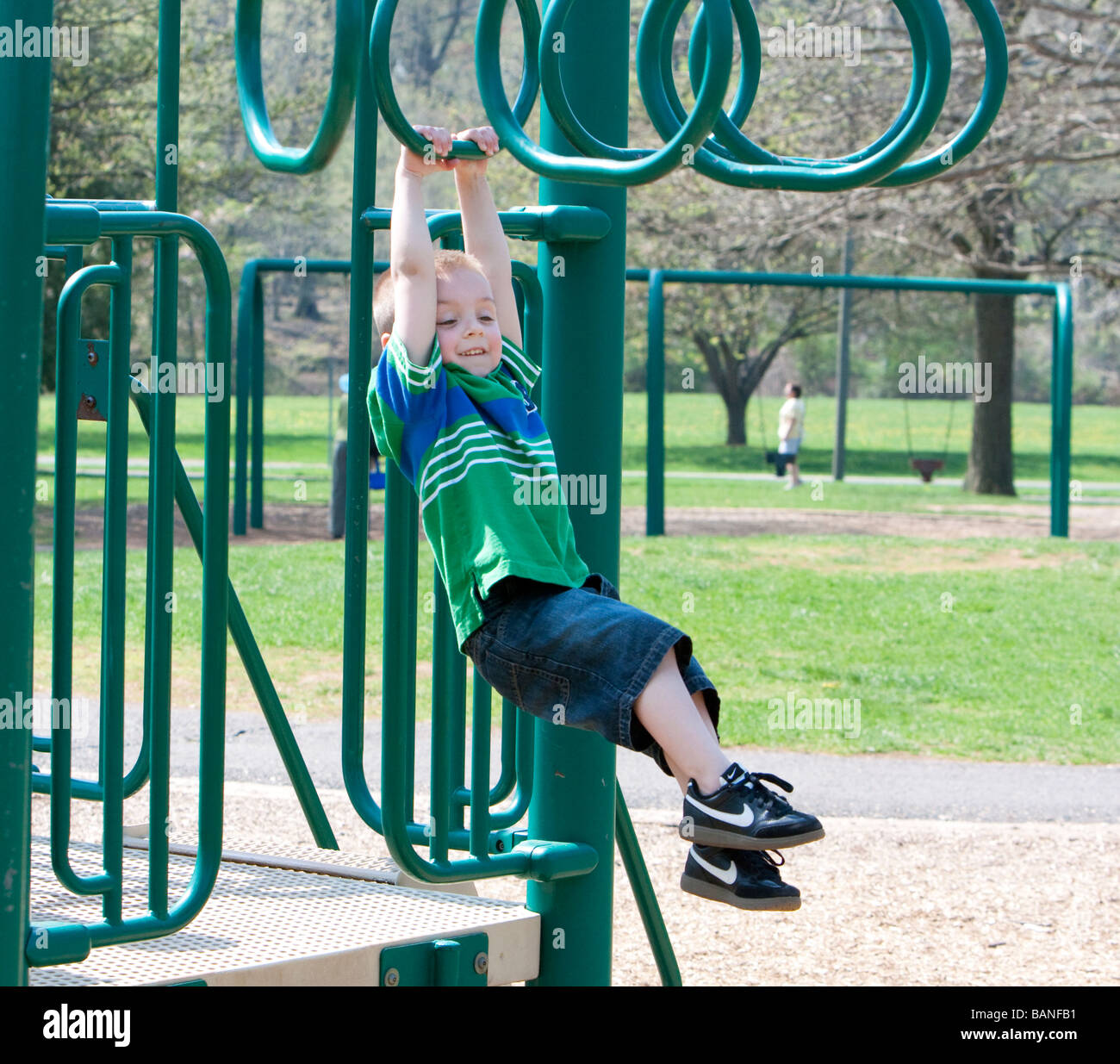 A young child climbing climbing on a playground playset Stock Photo - Alamy