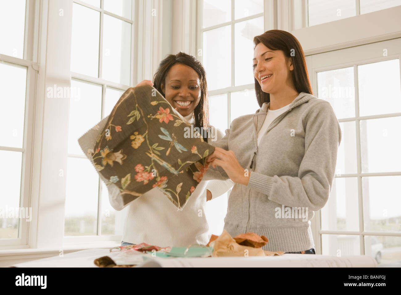 Women holding fabric swatch Stock Photo - Alamy