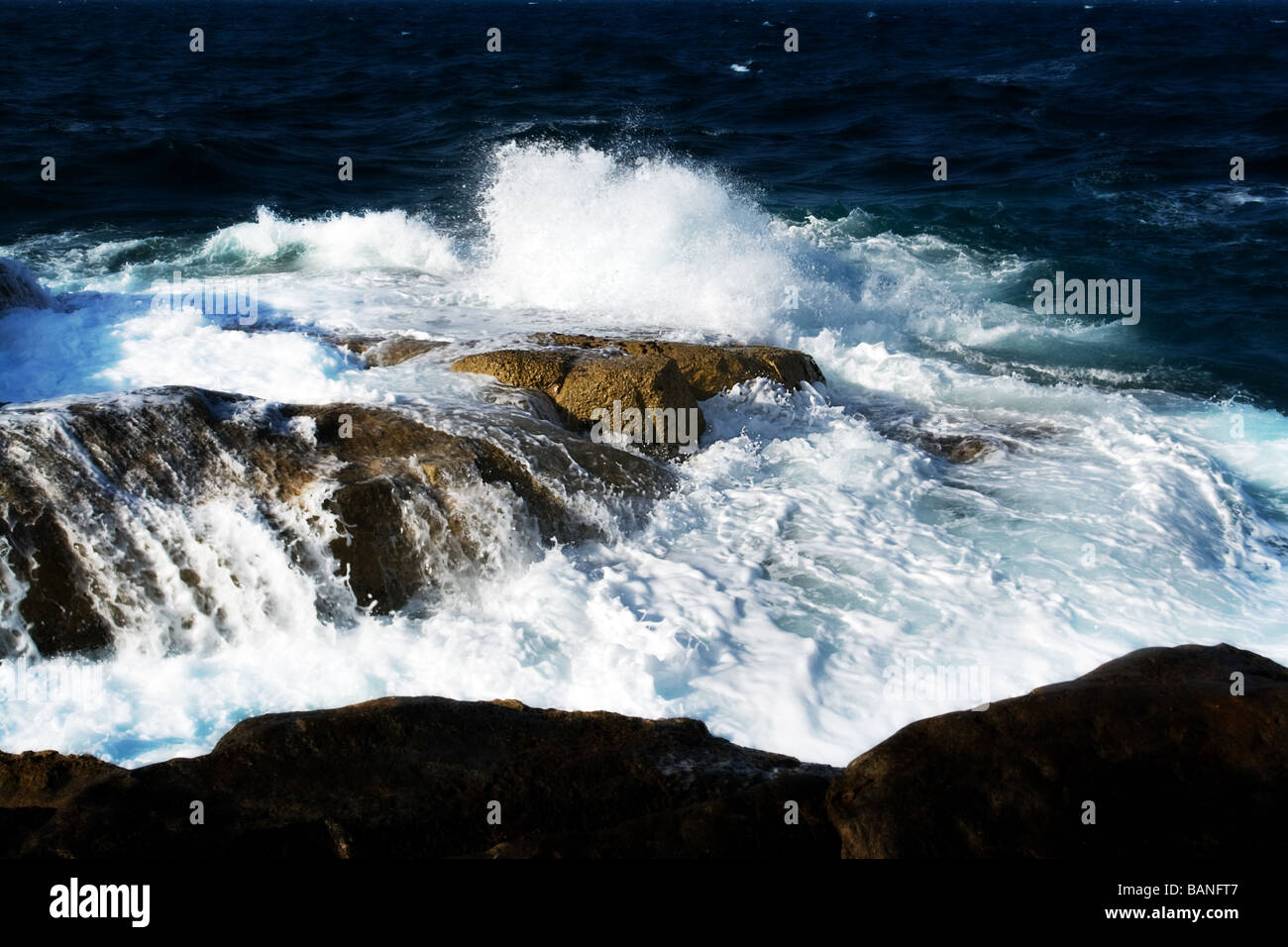Waves splashing against rocks Stock Photo - Alamy