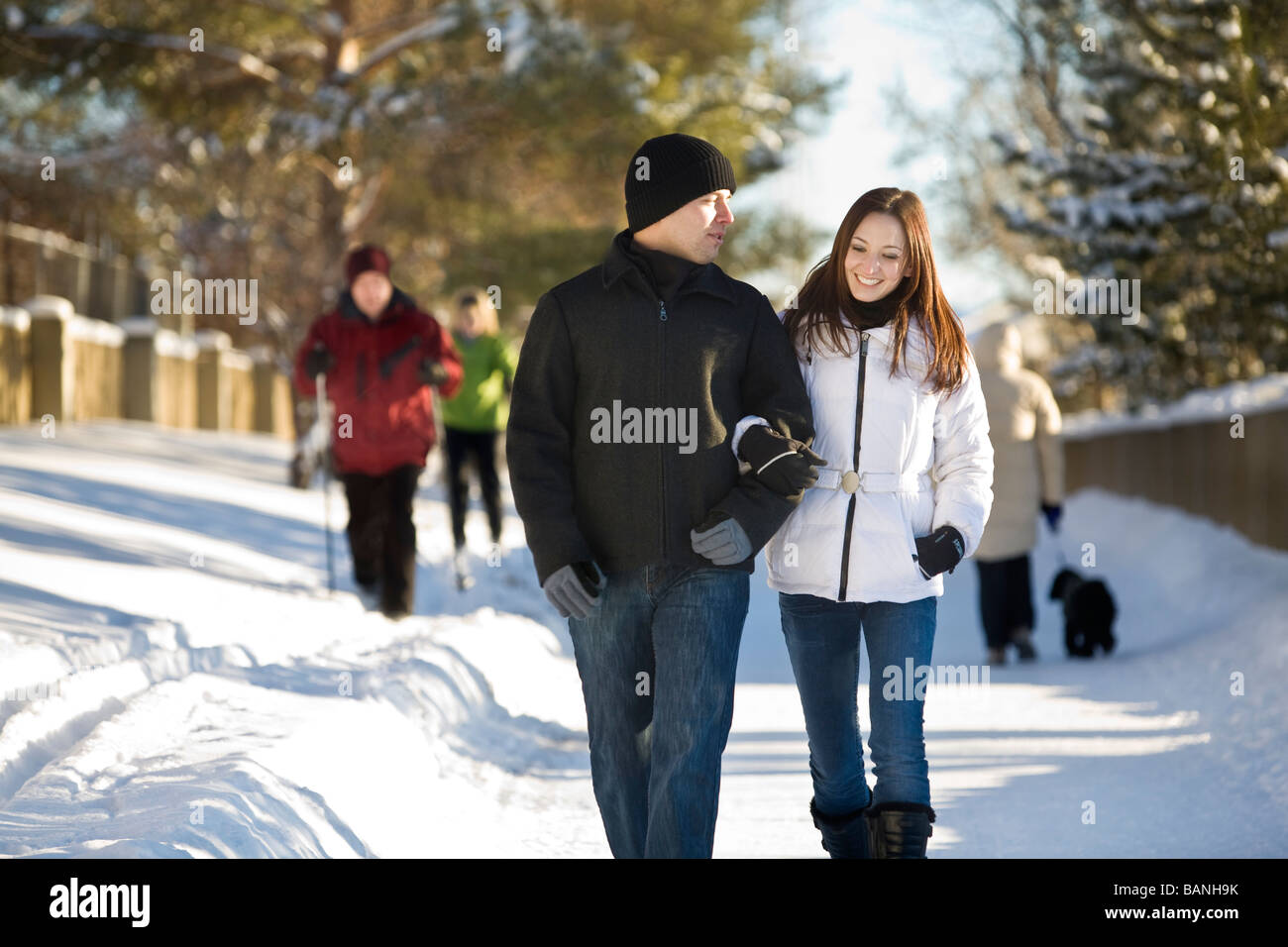 Couple walking on winter paths Stock Photo - Alamy