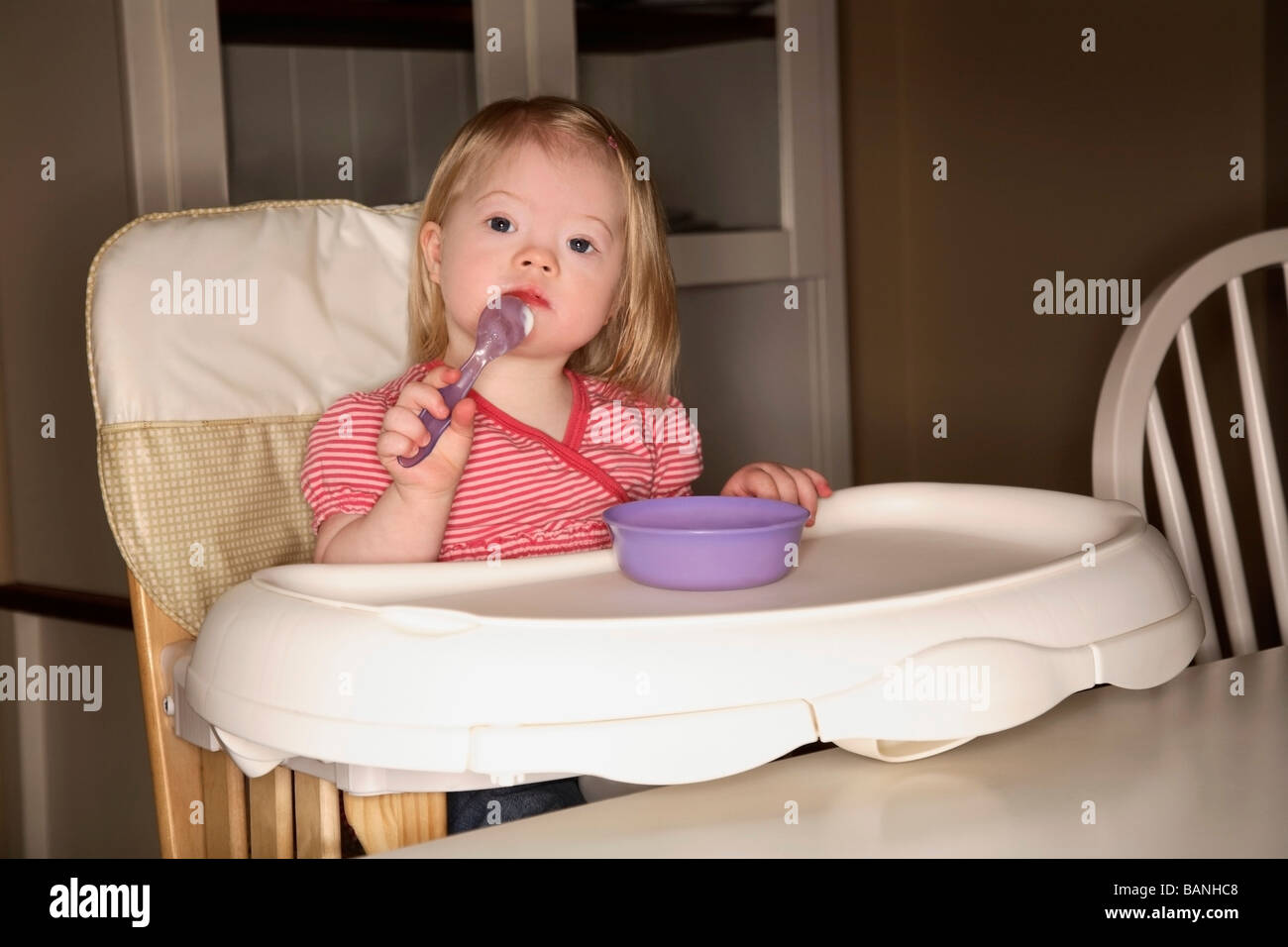 Girl in a high chair Stock Photo - Alamy
