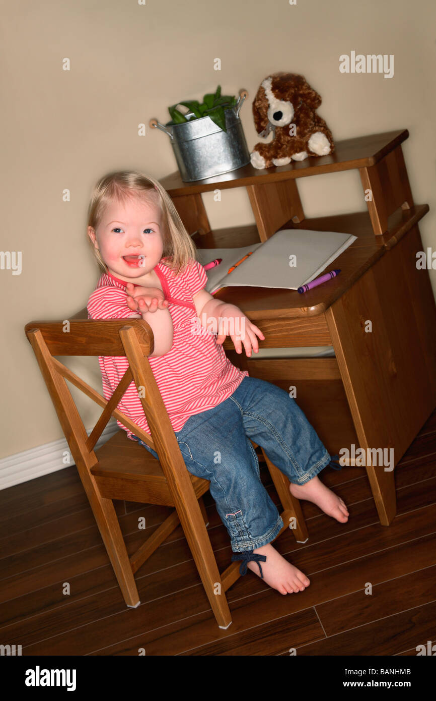 Young girl sitting at her desk Stock Photo - Alamy
