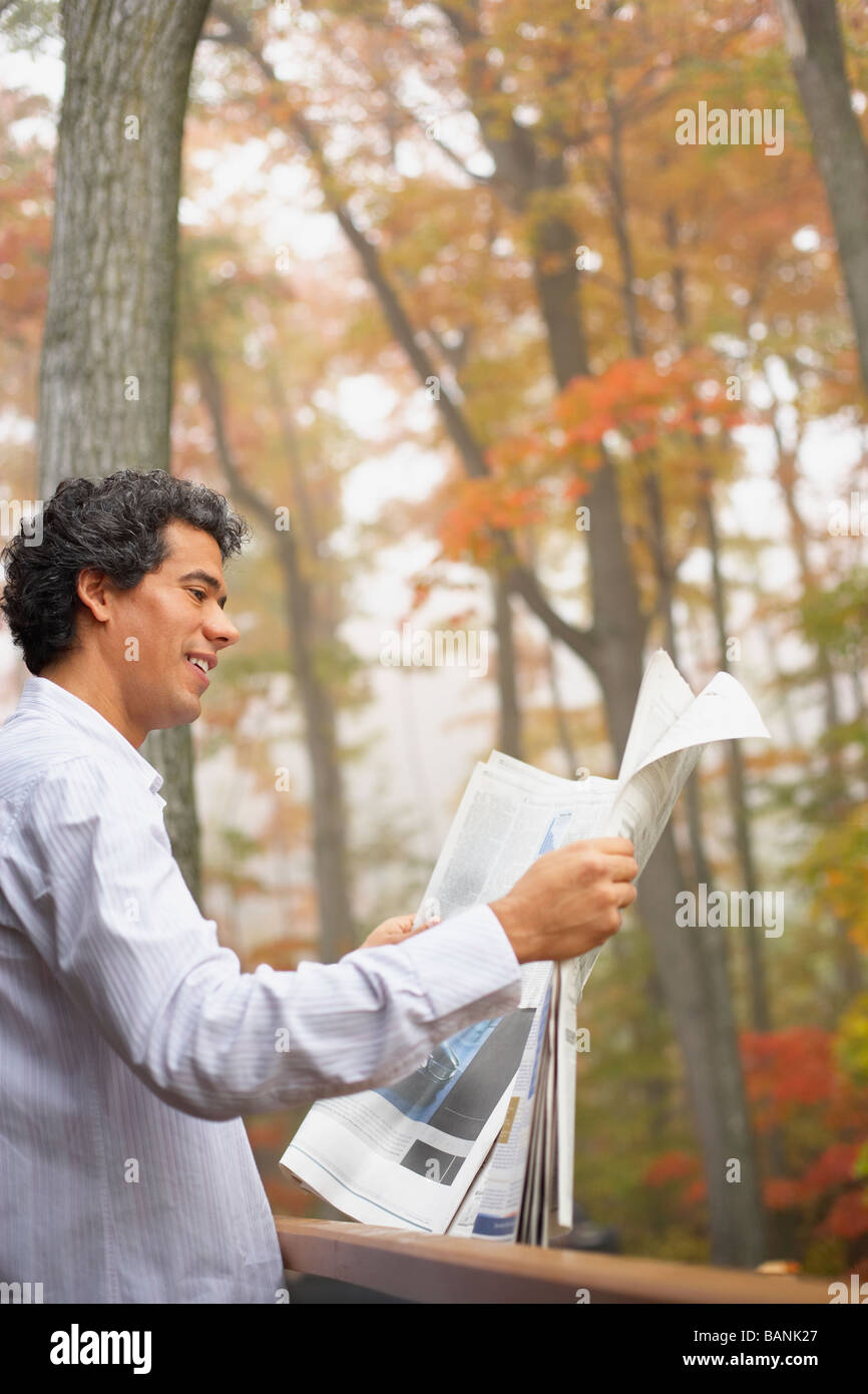 Man reading newspaper outdoors Stock Photo - Alamy